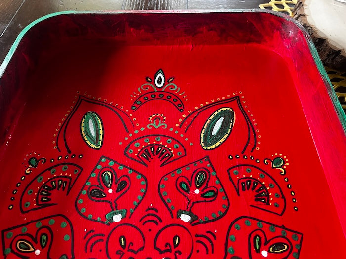 A red hand painted wooden serving tray